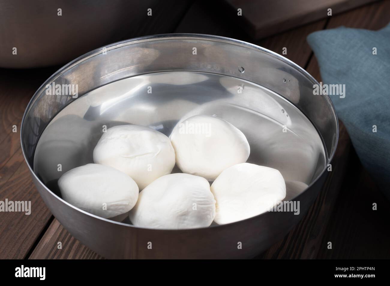 Making mozzarella cheese. Cooling the finished balls in cold water Stock Photo - Alamy