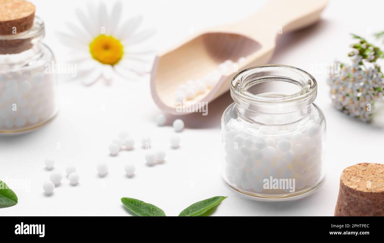 Composition of homeopathic medicines and medicinal plants on a white ...