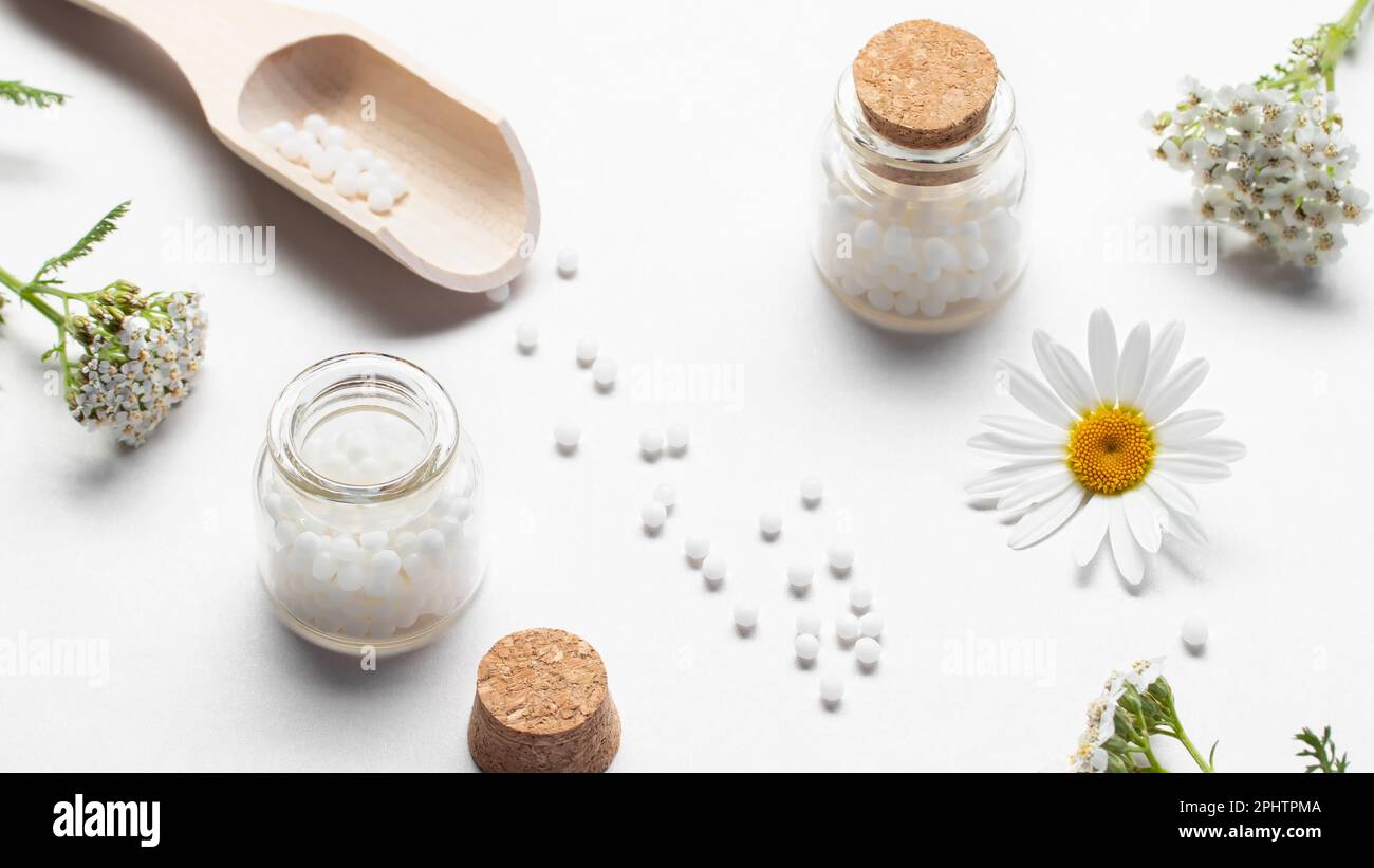 Composition of homeopathic medicines and medicinal plants on a white ...