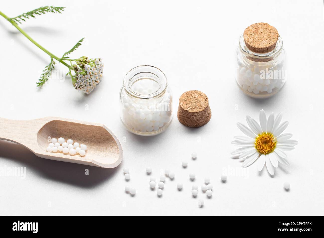 Composition of homeopathic medicines and medicinal plants on a white ...
