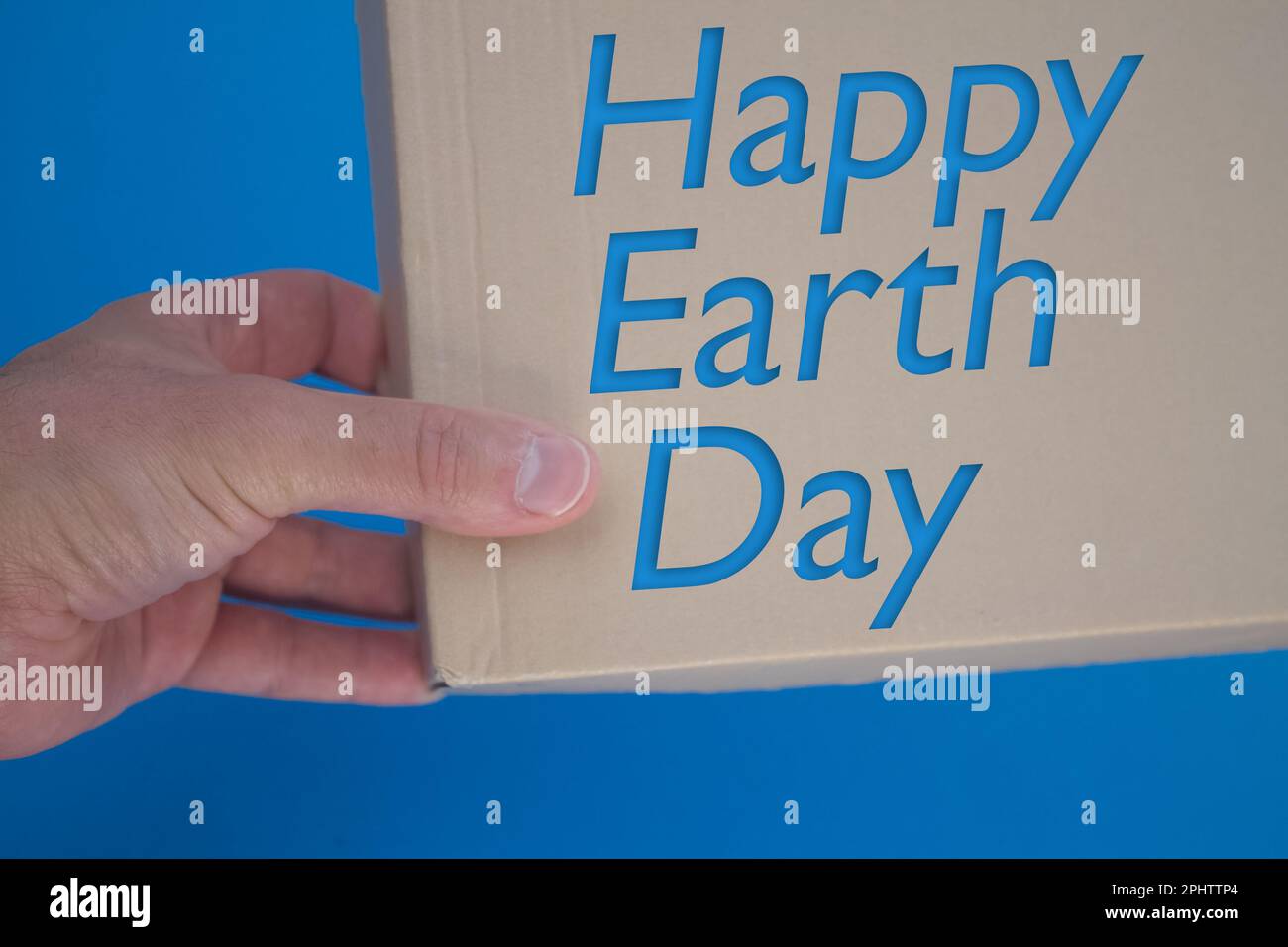 Earth Day word with cardboard box. Brown folded card box Stock Photo ...