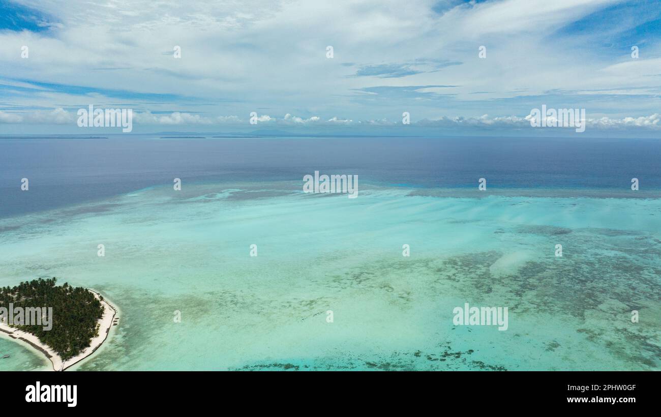 Island in the blue sea with a coral reef and the beach iew from above ...
