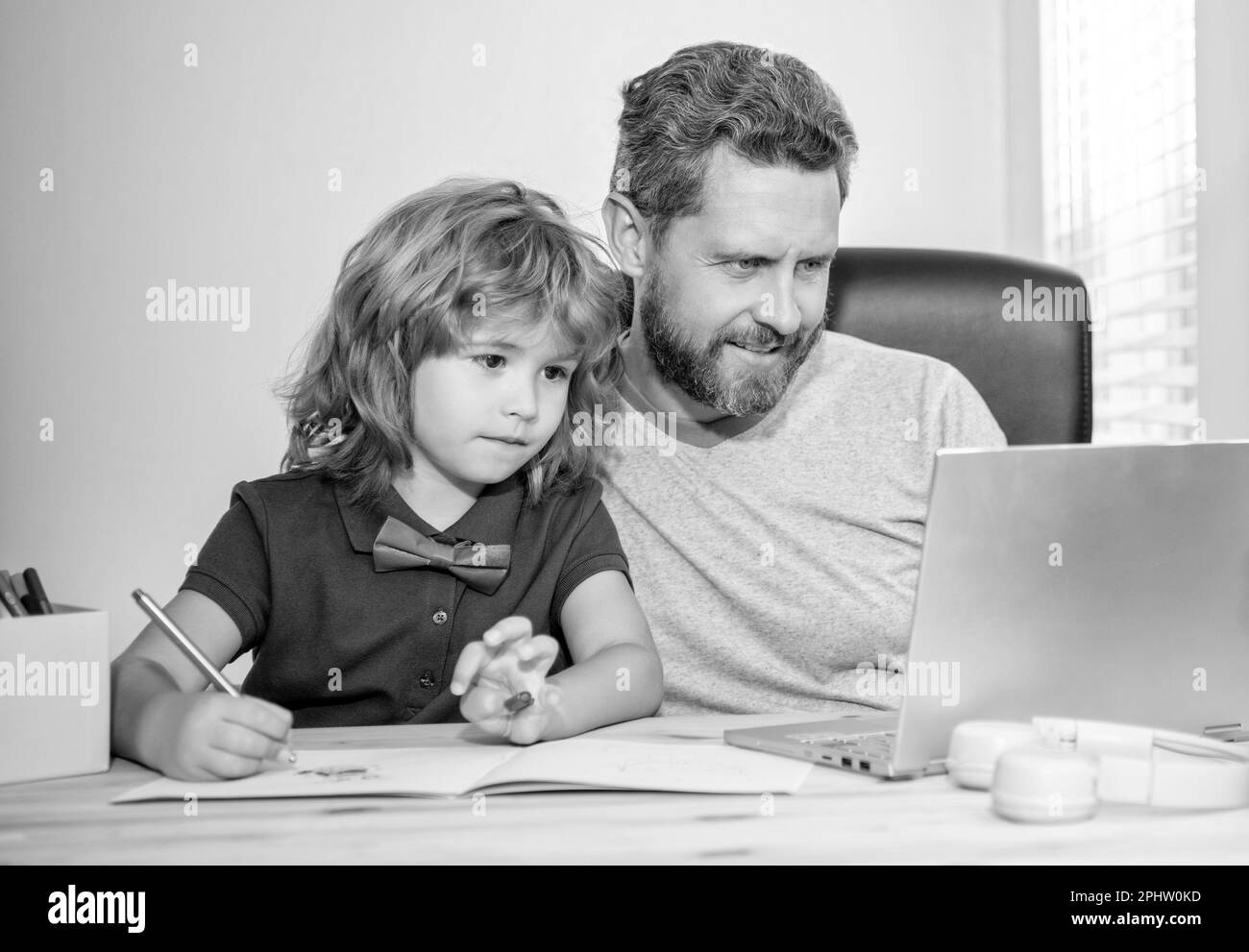 mature man teacher or dad helping kid son with school homework on ...