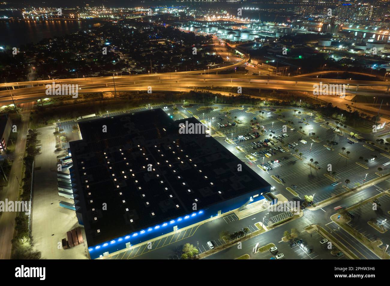 Aerial night view of many cars parked on parking lot with lines and ...