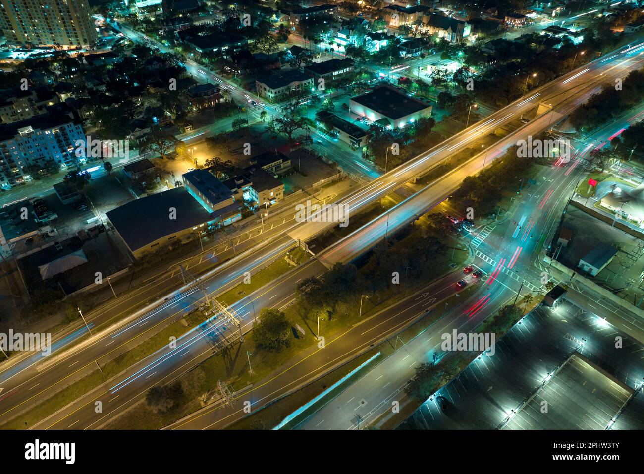 Aerial view of american freeway intersection at night with fast driving ...