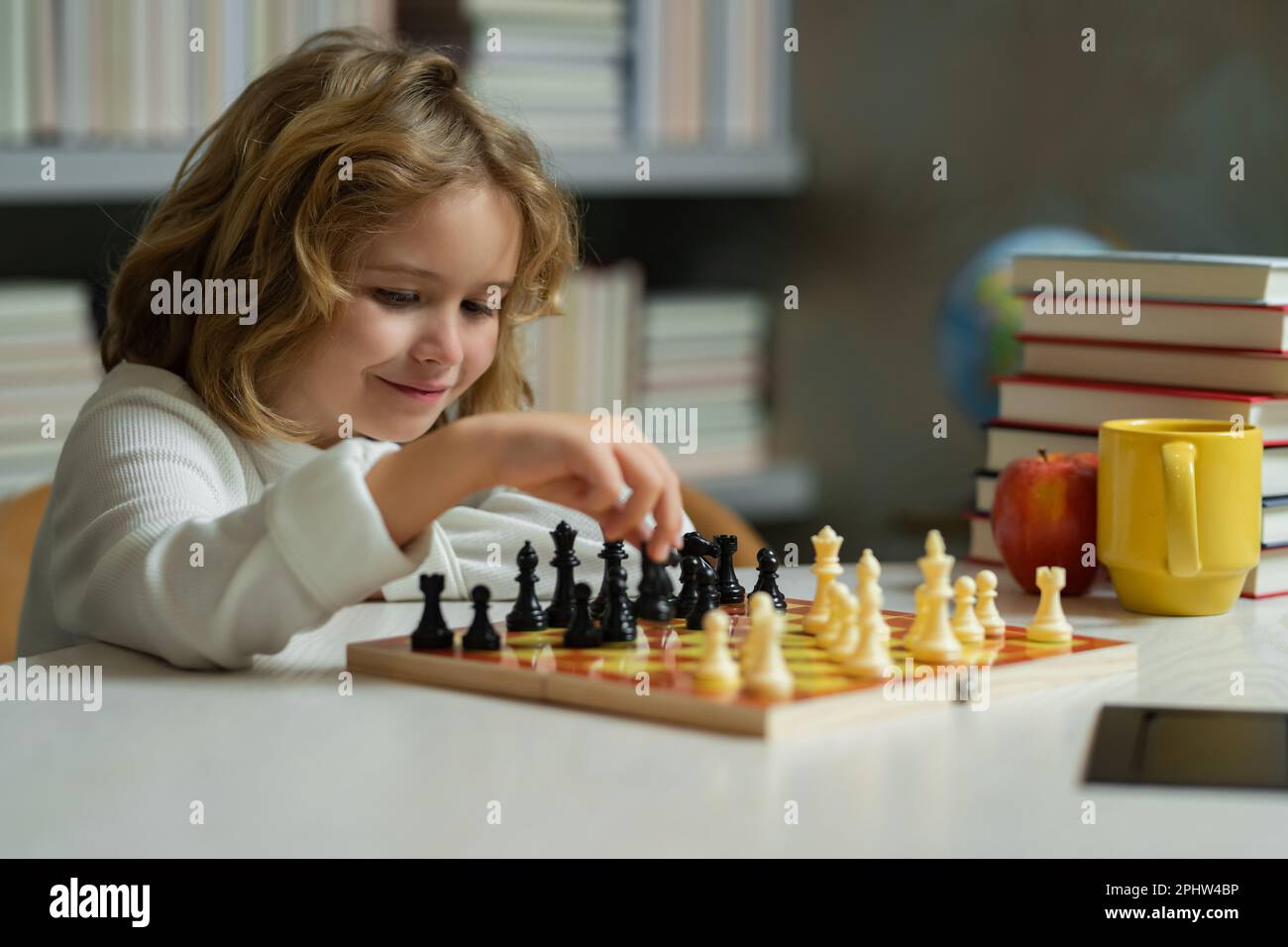 Concentrated child play chess. Brain development and logic. Kid playing ...