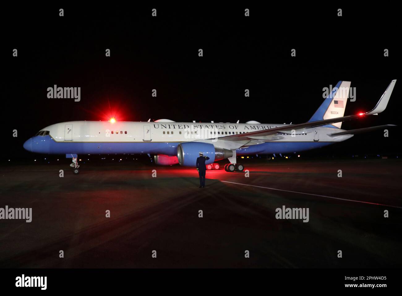 A military officer salutes Air Force Two with U.S. Vice President ...