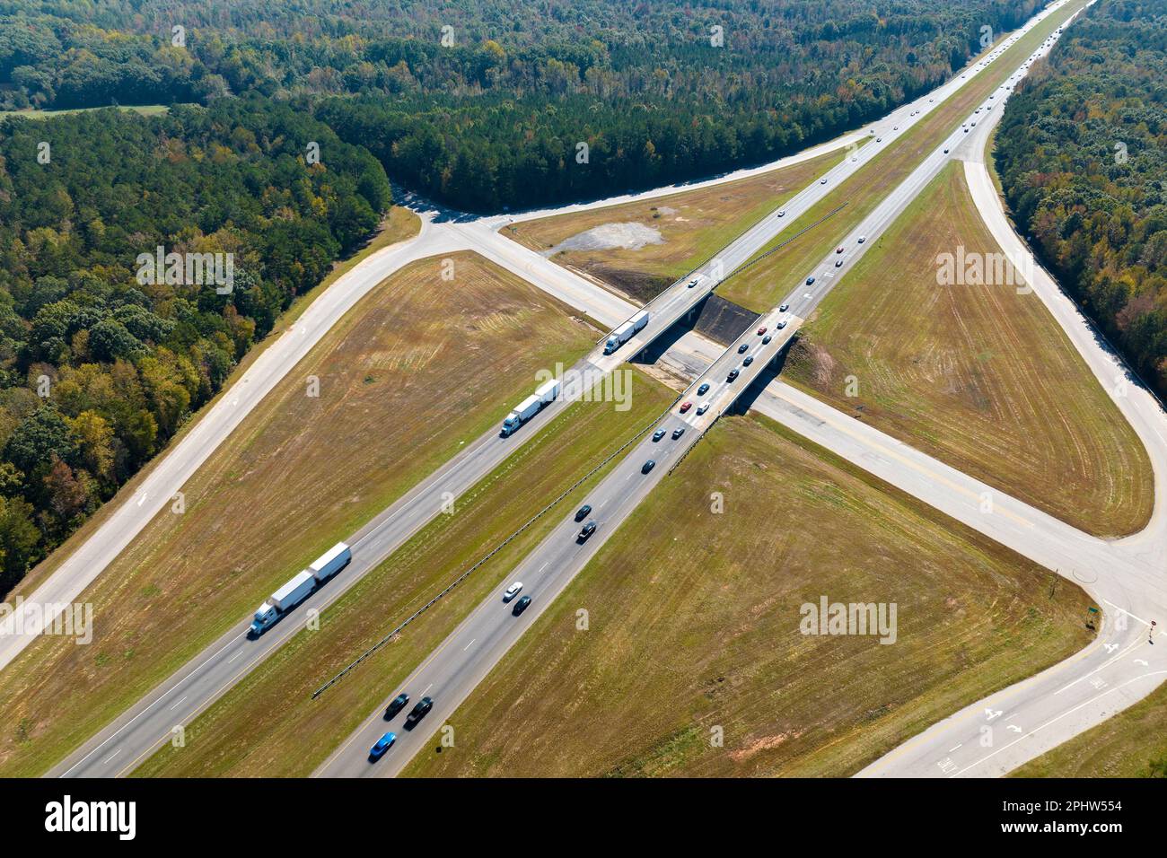 Aerial view of freeway overpass junction with fast moving traffic cars ...