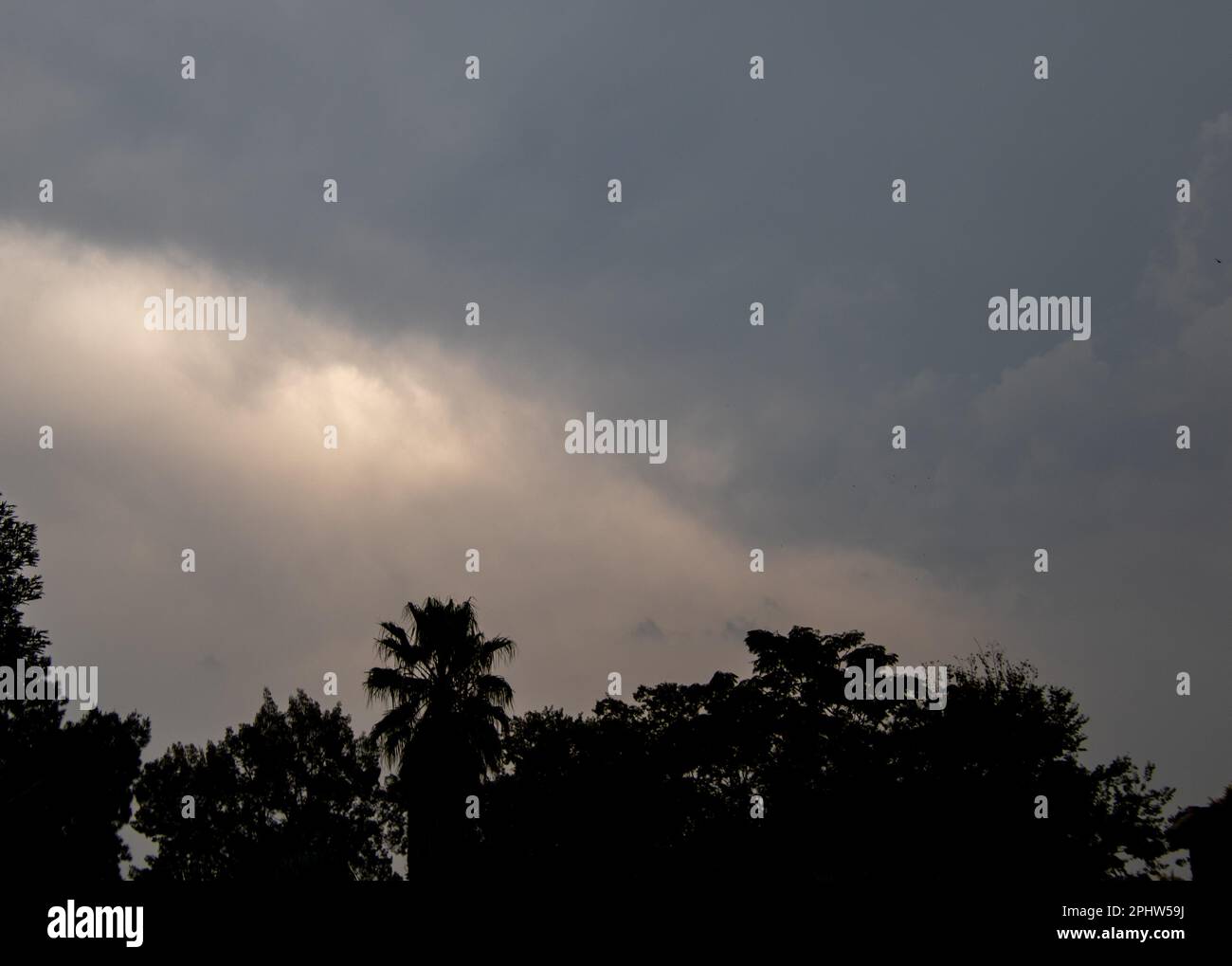 Late summer storm clouds build up in the sky south of the city of ...