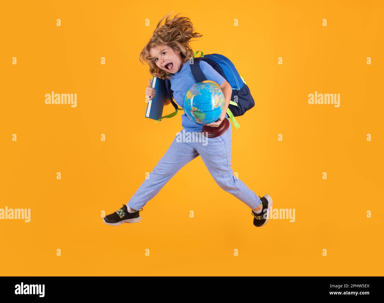Shool kid jump with school bag and globe. Funny excited school concept ...