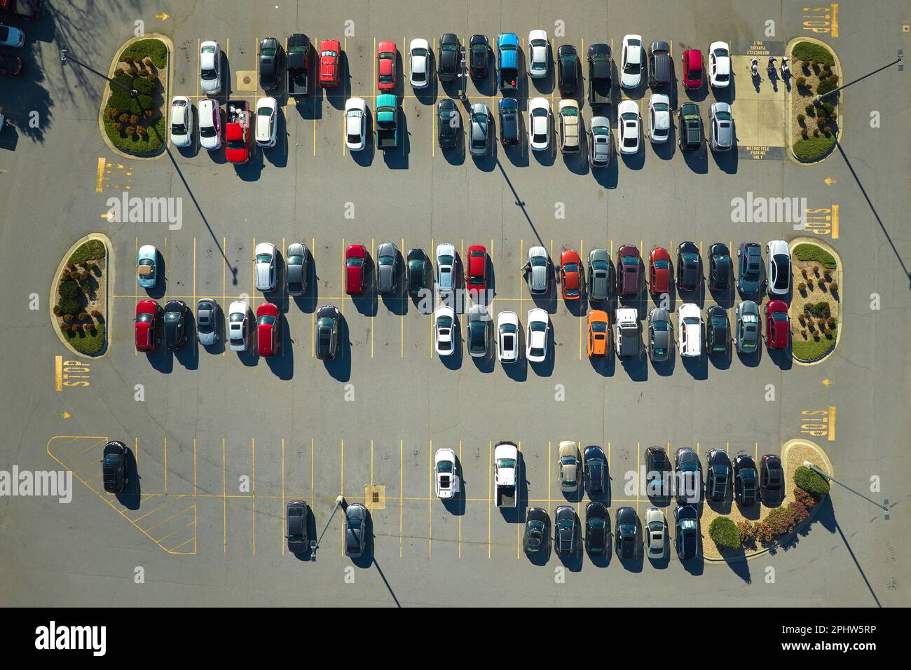 Aerial view of many colorful cars parked on parking lot with lines and ...