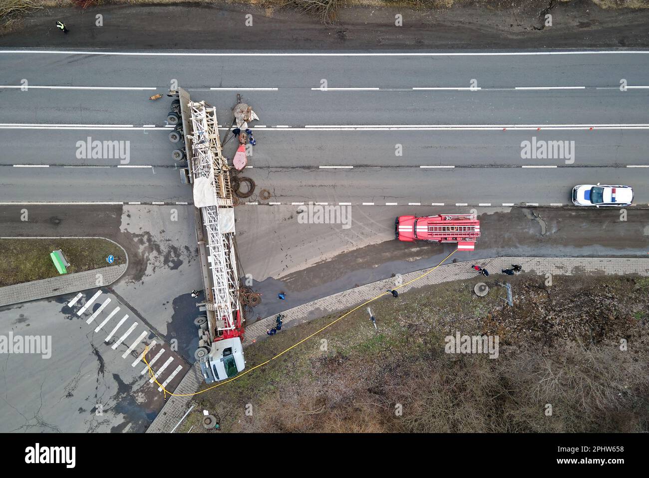 Aerial view of road accident with overturned truck blocking traffic ...