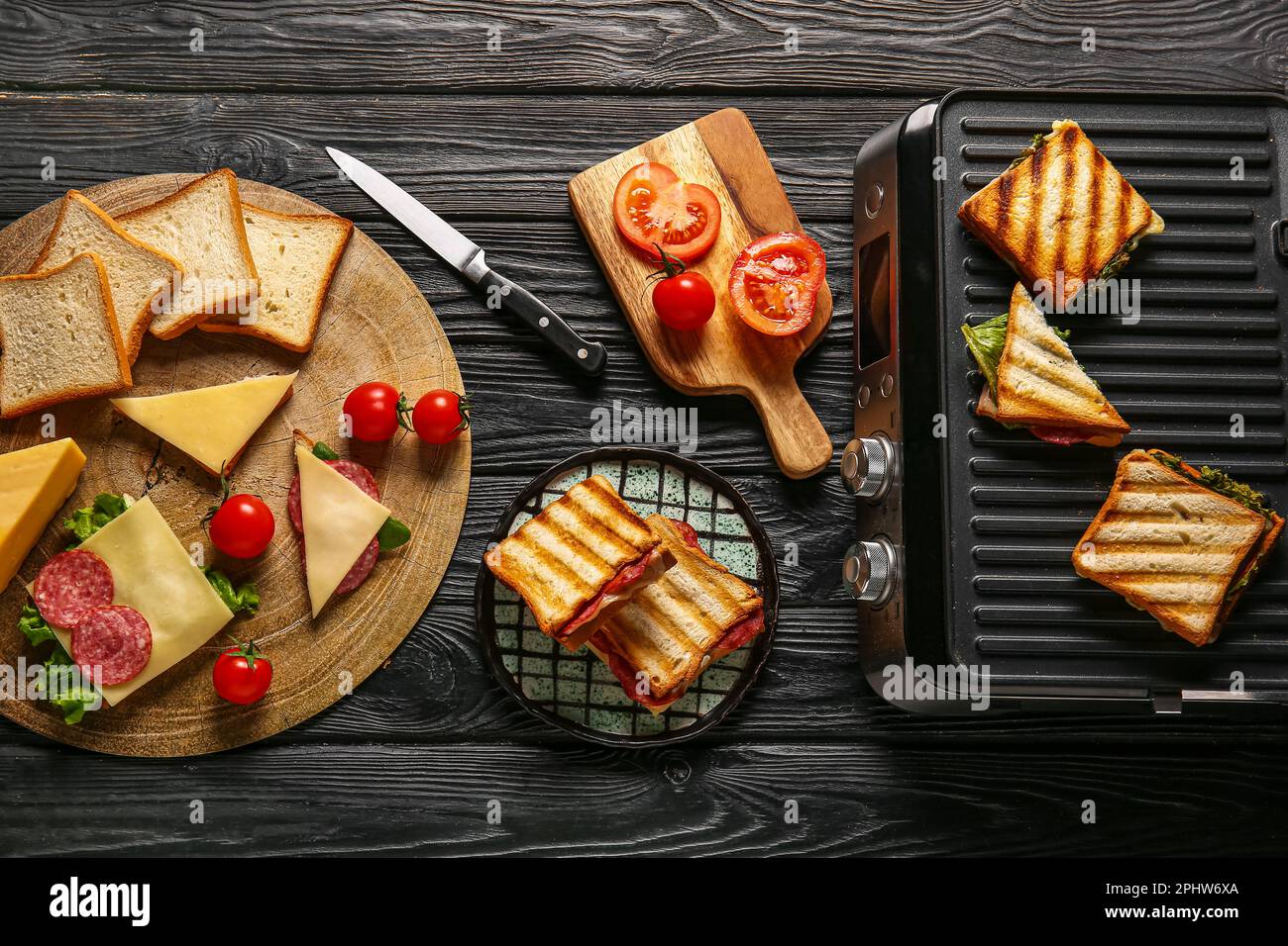 Composition with modern electric grill, delicious sandwiches and ...