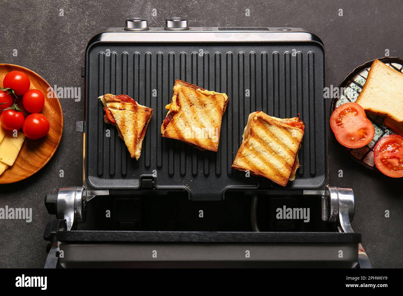 Composition with modern electric grill, delicious sandwiches and ...