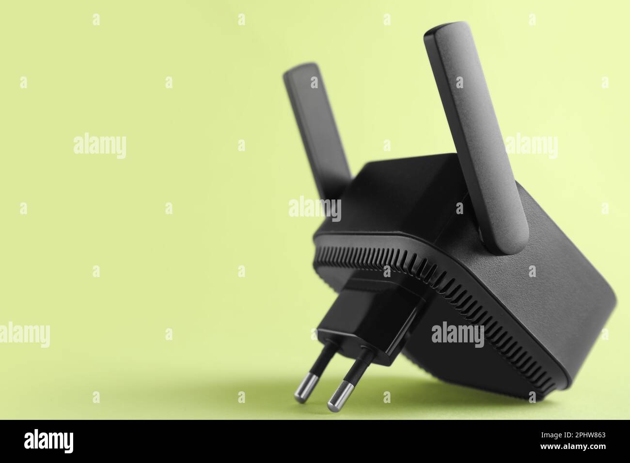 Black WiFi repeater on green background Stock Photo - Alamy