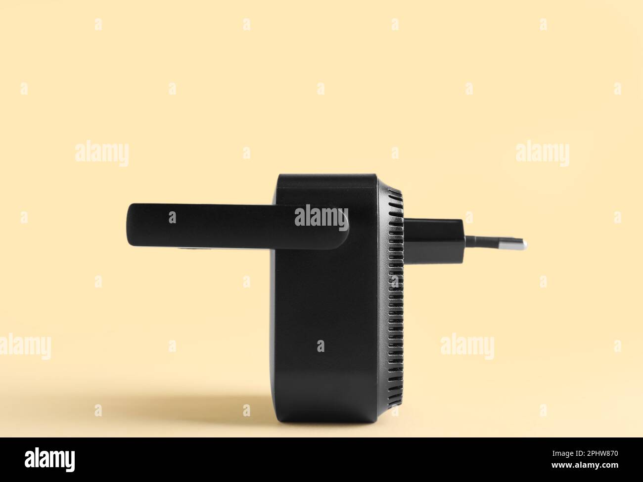 Black WiFi repeater on beige background Stock Photo - Alamy