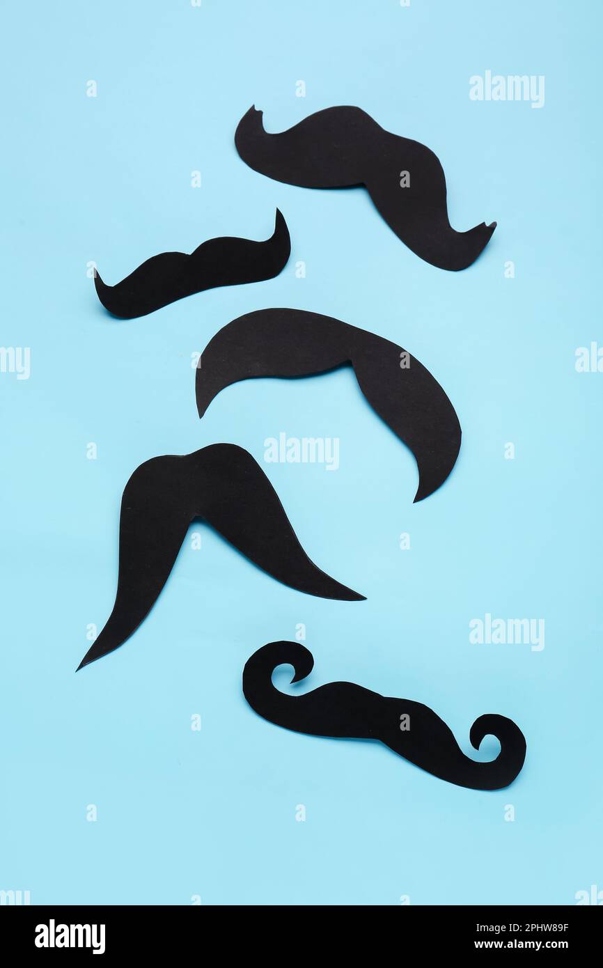 Set of paper mustaches on color background Stock Photo - Alamy
