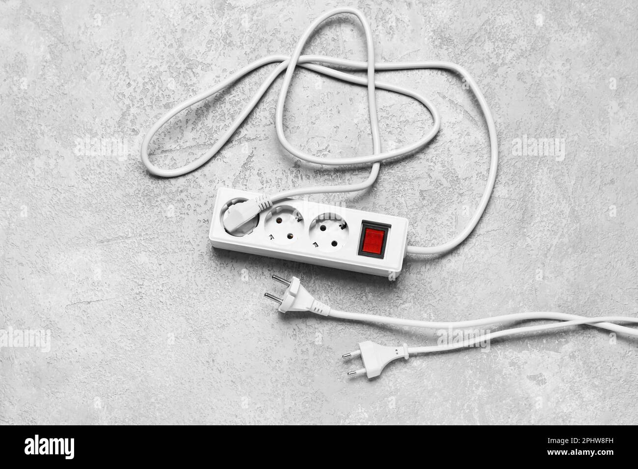Electric extension cord with plugs on grey grunge background Stock ...