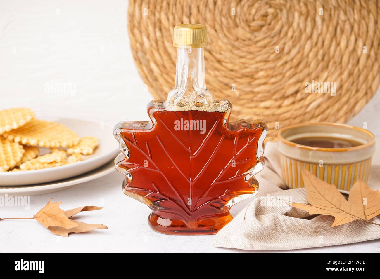 Beautiful composition with bottle of maple syrup and waffles on white ...