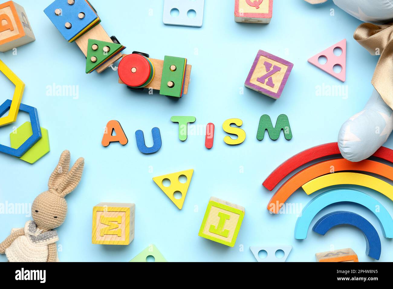 Word AUTISM with baby toys on blue background. World Autism Awareness ...