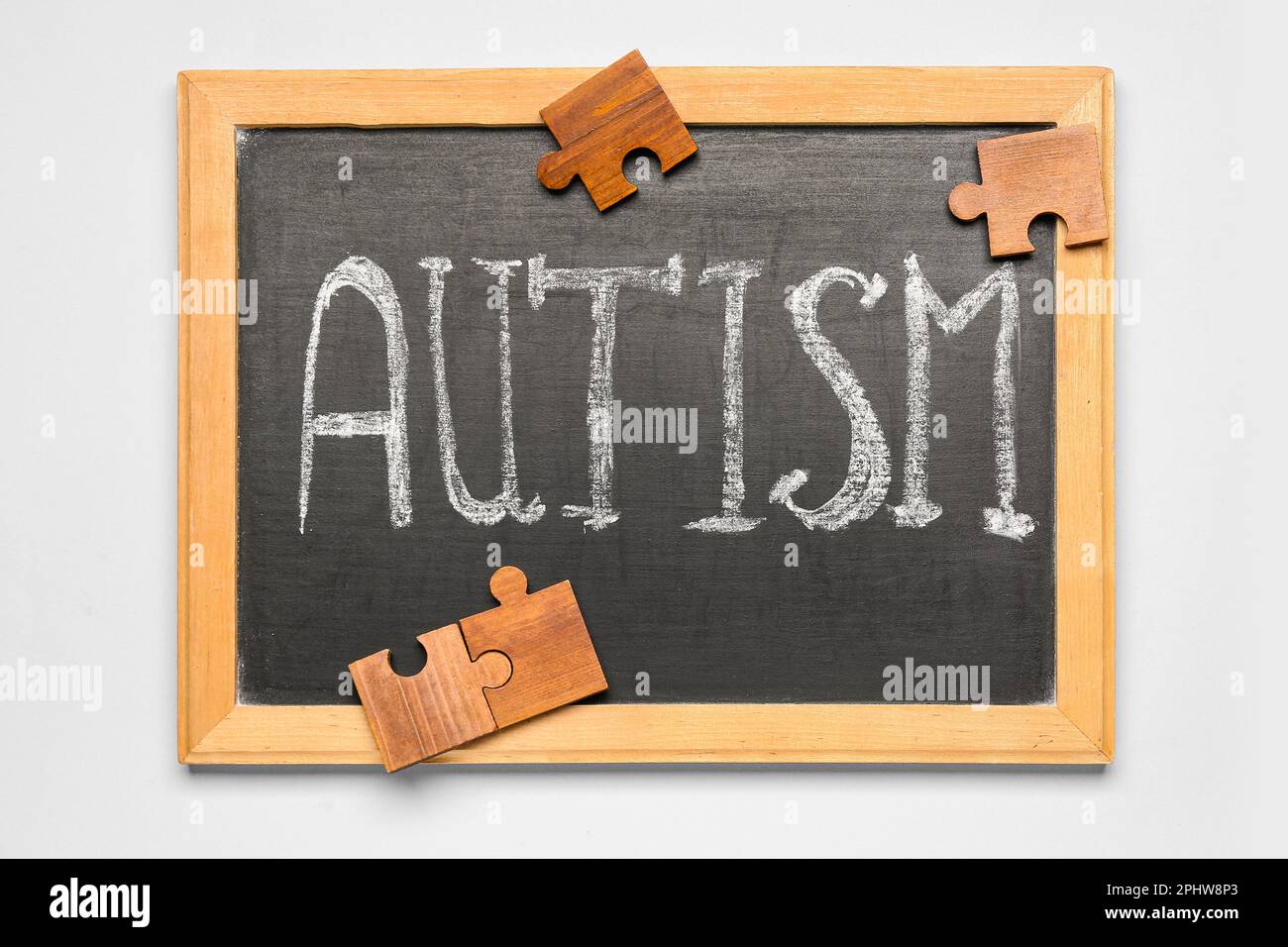 Chalkboard with word AUTISM and puzzle pieces on grey background Stock ...