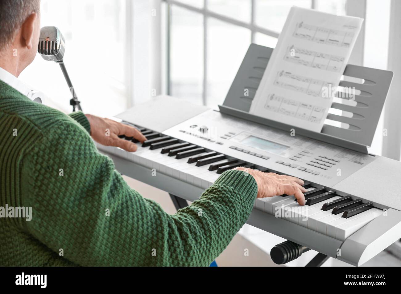 Professional musician playing singing home hi-res stock photography and ...