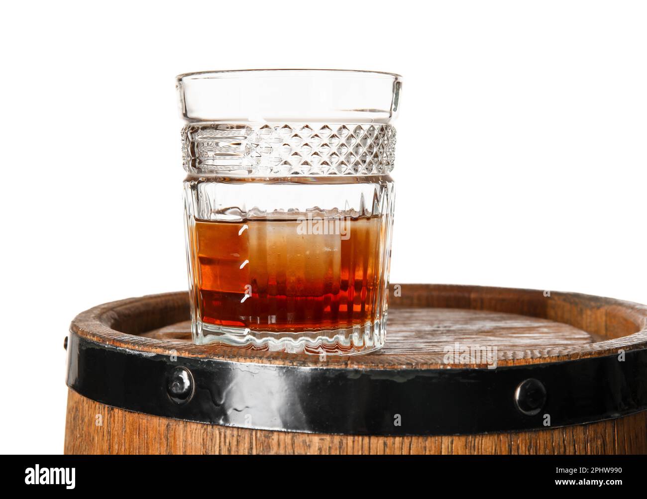 Glass of cold rum on wooden barrel against white background Stock Photo ...