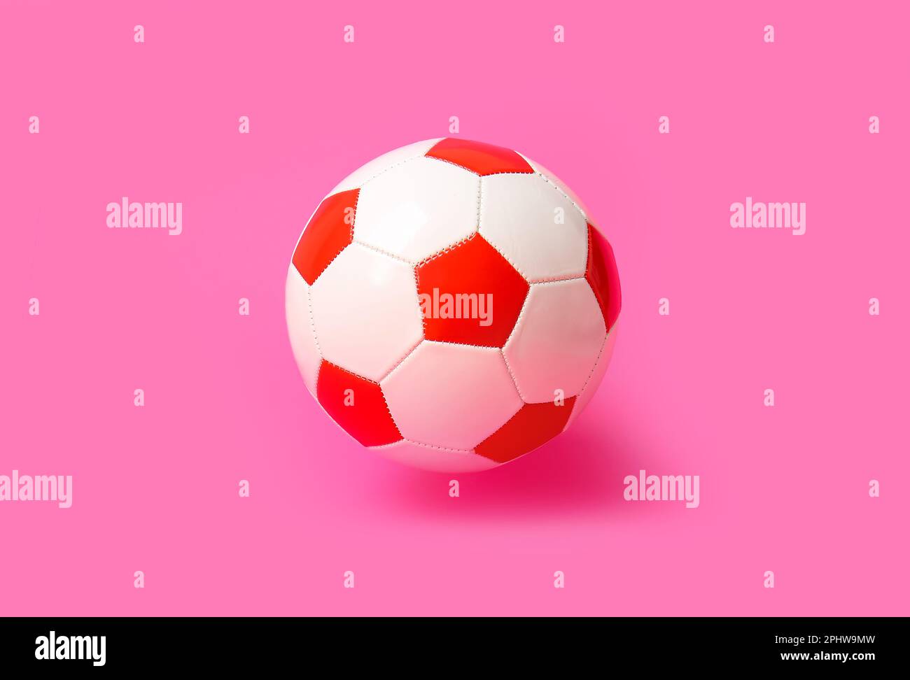Soccer ball on pink background Stock Photo - Alamy