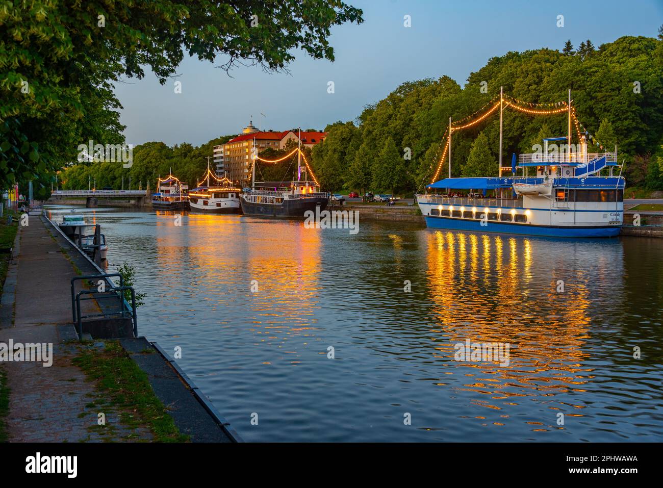 Sunset view of boats mooring alongside river Aura in Turku, Finland ...