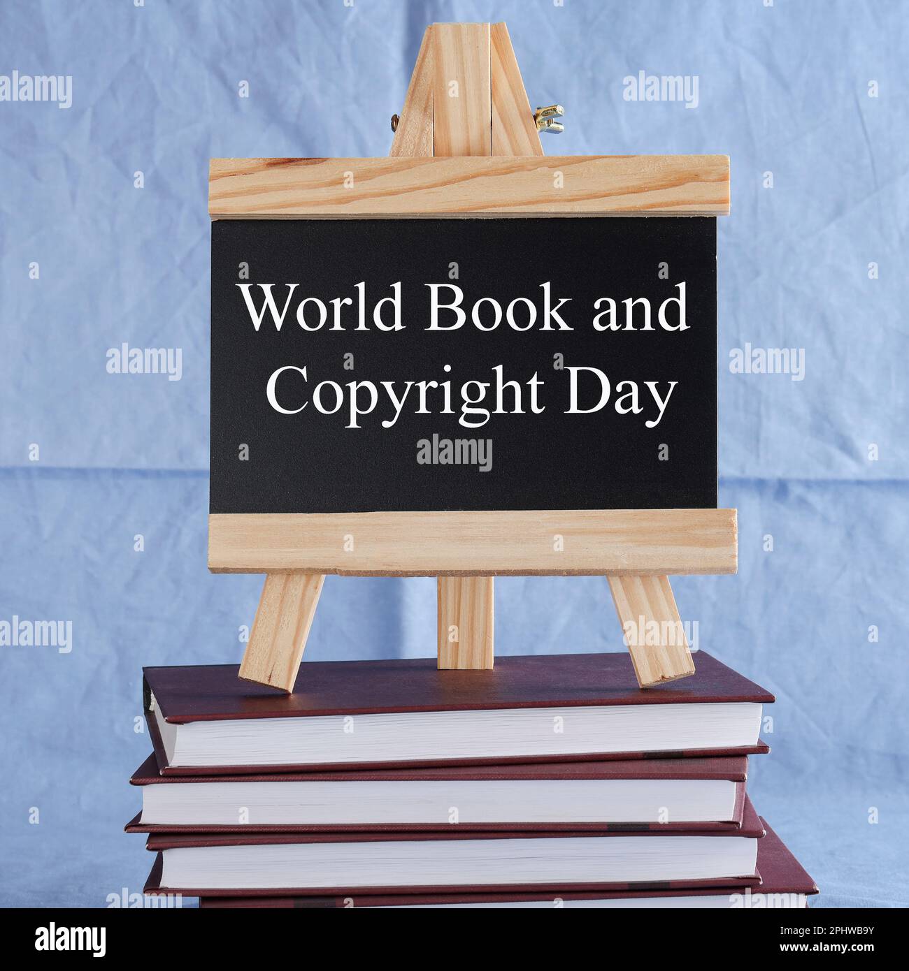 World Book and Copyright Day written on black board on stack of books ...