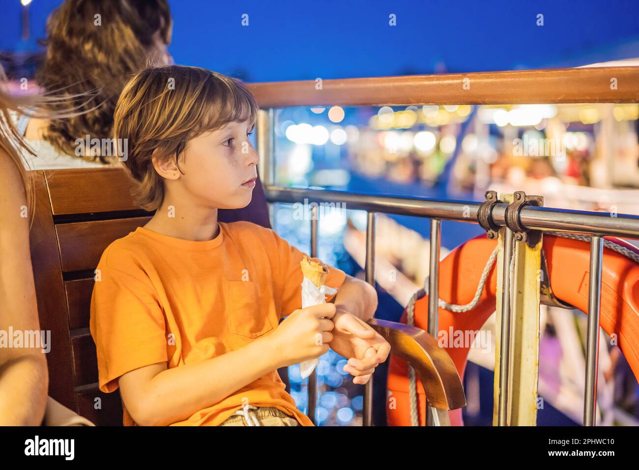 Boy tourist boy eating turkish ice cream by ferry in the Bosphorus ...
