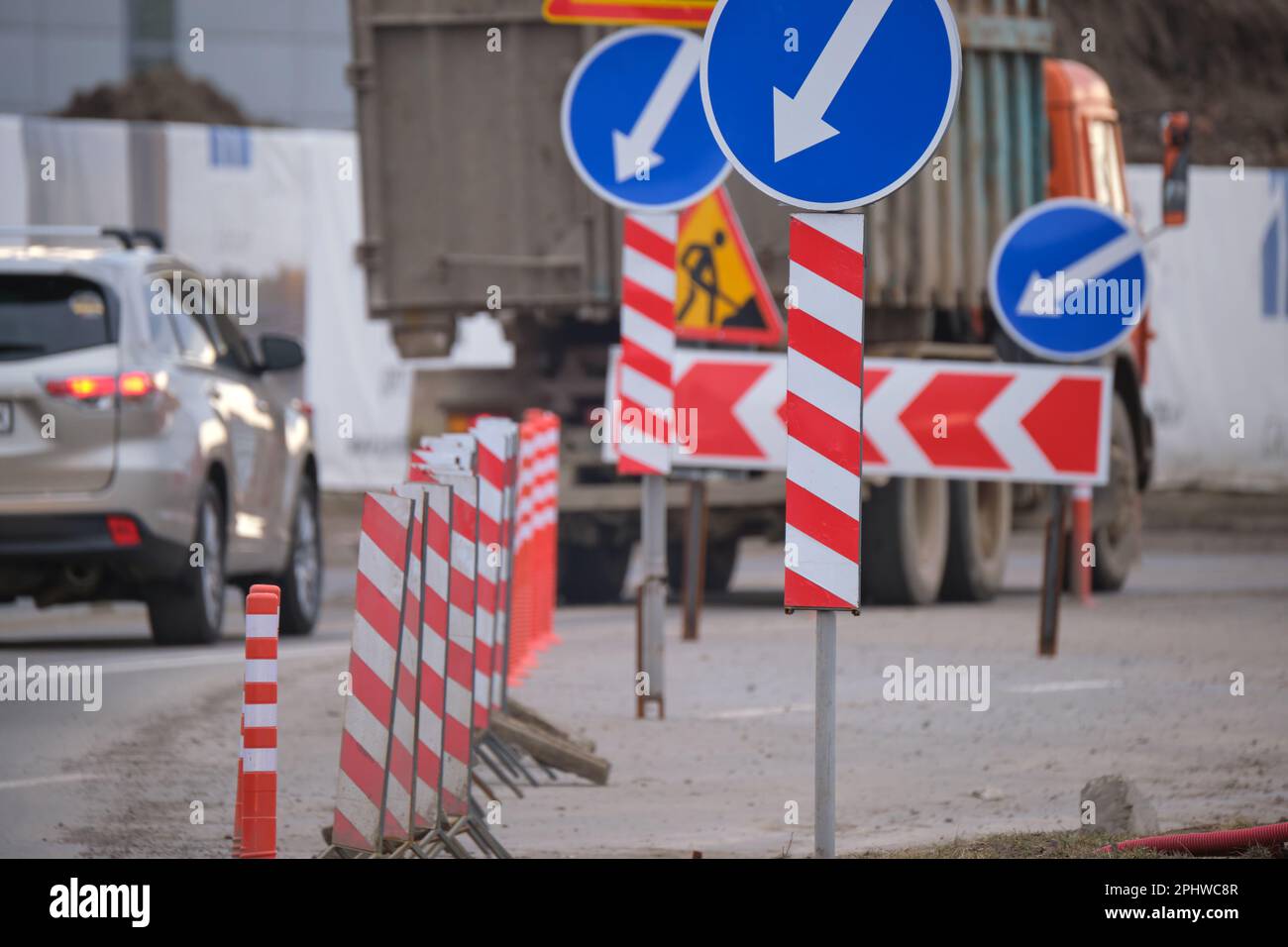 Roadworks warning traffic signs of construction work on city street and ...