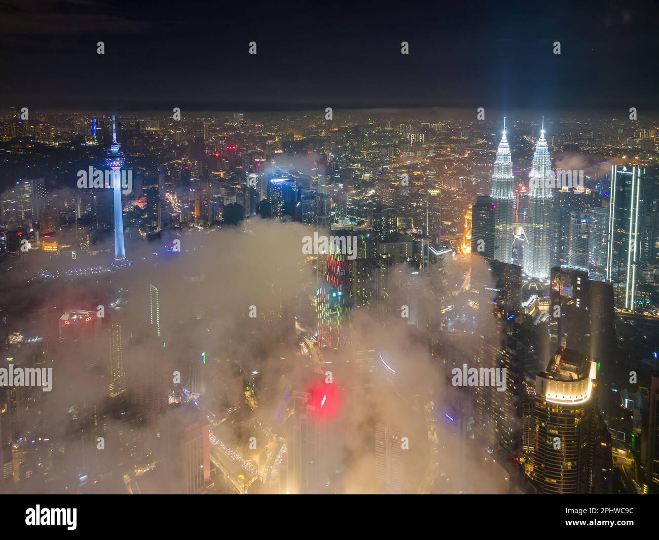 Kuala Lumpur cloudy night view in night. KLCC and KL Tower illuminated ...