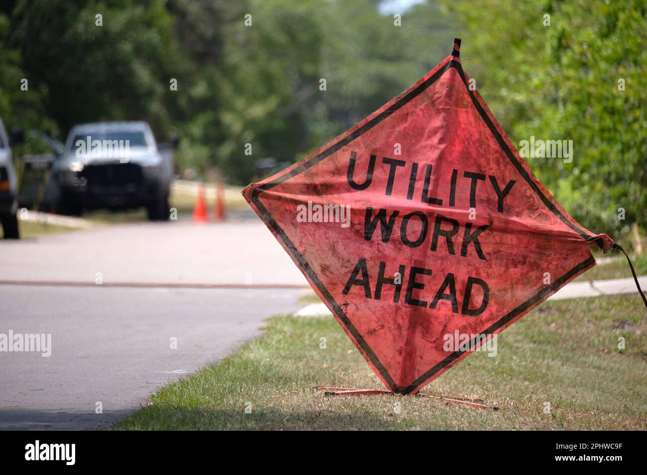 Road work ahead sign on street site as warning to cars about construction and utility works ...