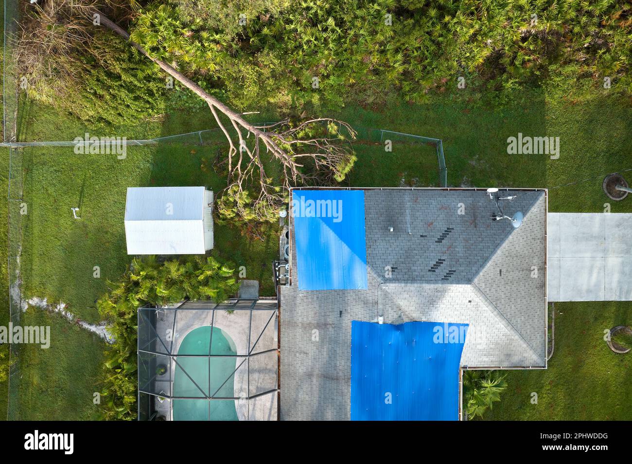 Top view of leaking house roof covered with protective tarp sheets ...