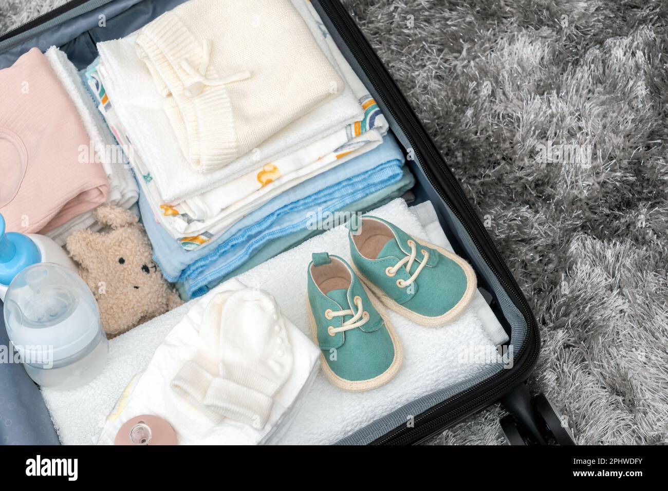 Top view of bag for maternity hospital. Suitcase of baby clothes ...