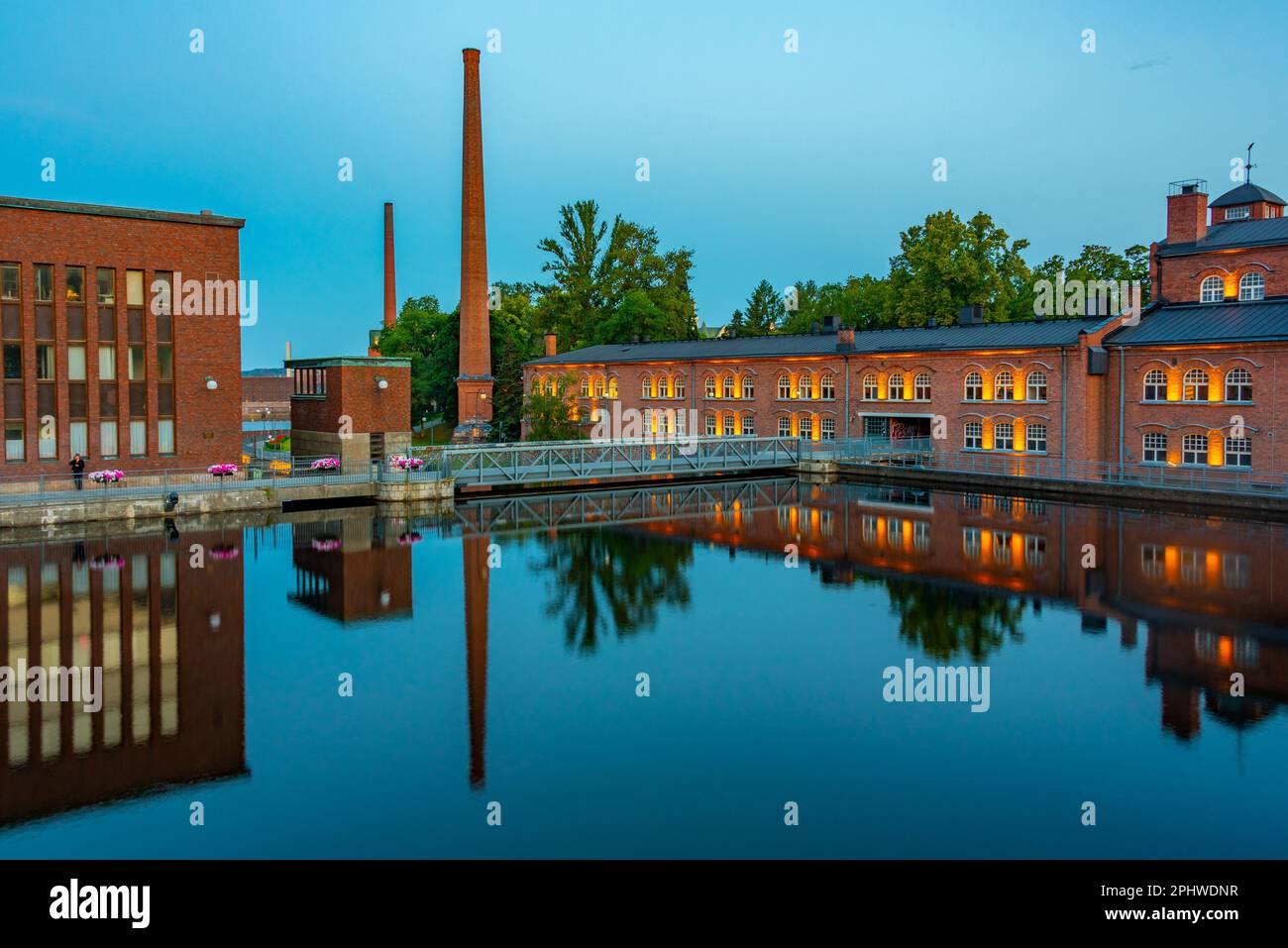 Sunset view of brick buildings alongside Tammerkoski channel in Tampere ...