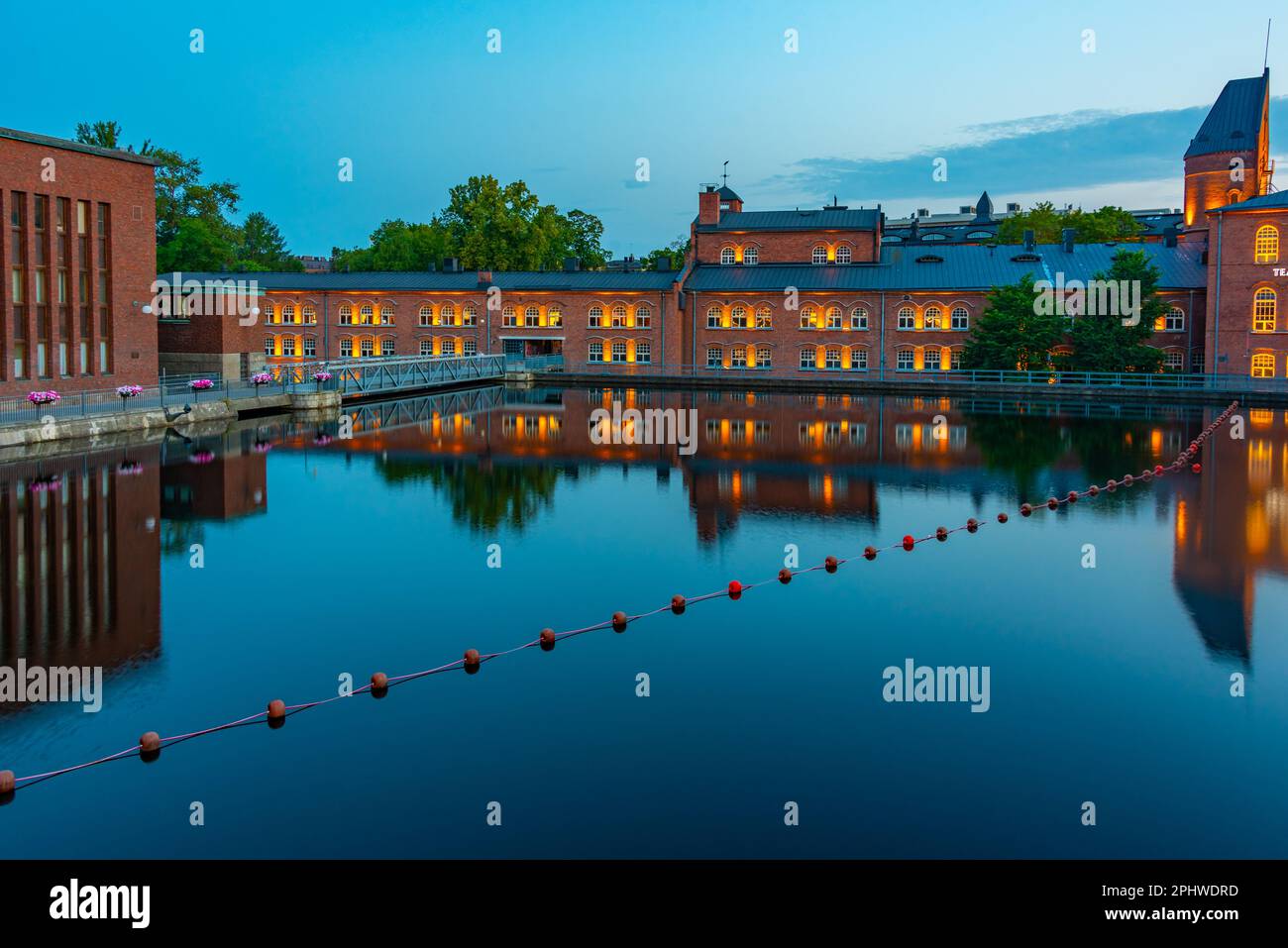 Sunset view of brick buildings alongside Tammerkoski channel in Tampere ...