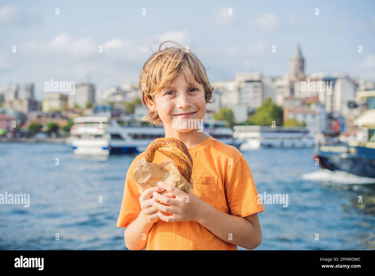 Boy in Istanbul having breakfast with Simit and a glass of Turkish tea ...