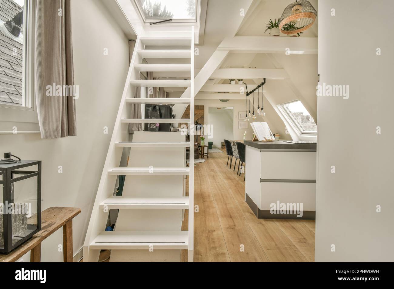 a room with some stairs and a window in the corner to the right, there ...