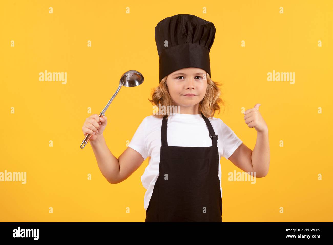 Funny kid chef cook with kitchen ladle, studio portrait. Child chef ...