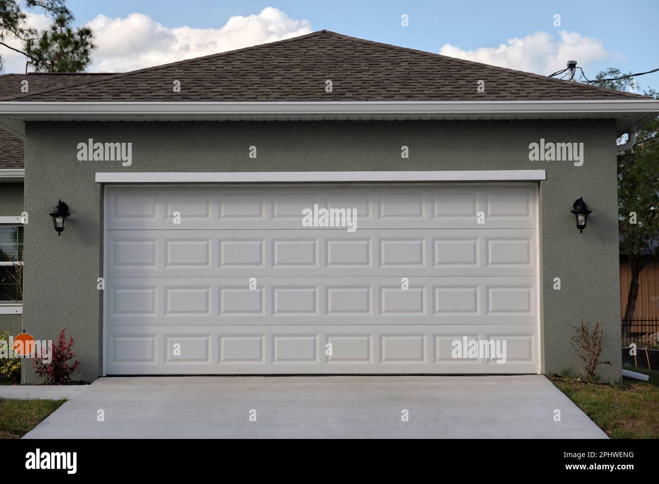 Wide garage double door and concrete driveway of new modern american ...