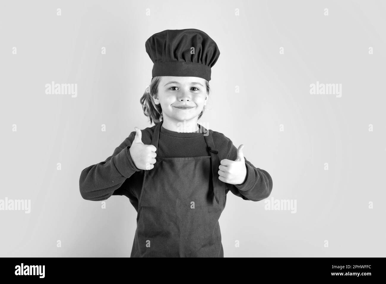 Child chef cook prepares food on isolated studio background. Kids ...
