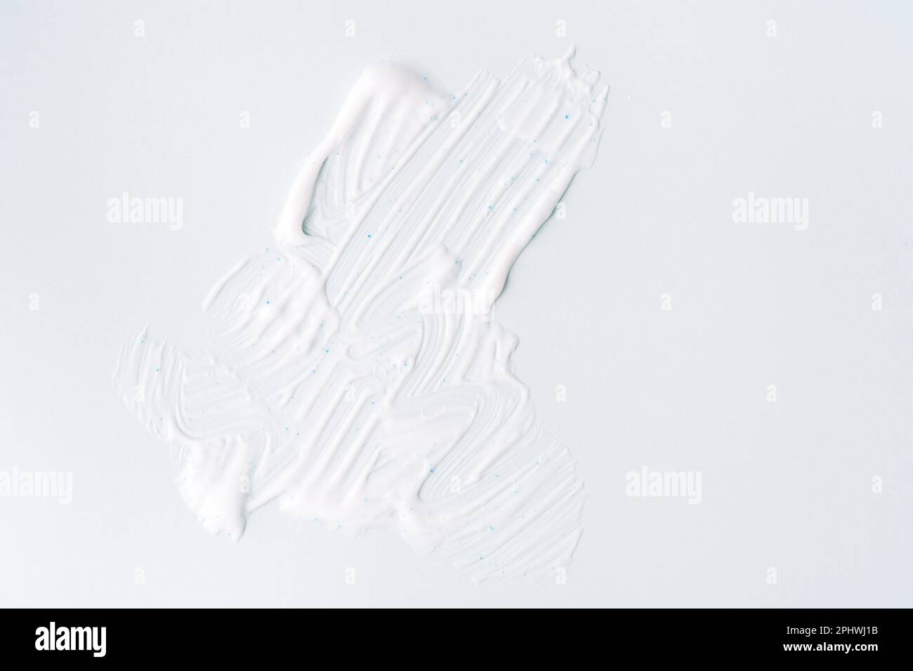 Smeared toothpaste over blue background Stock Photo - Alamy