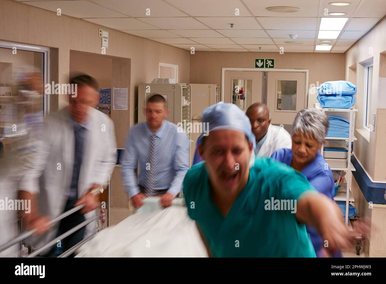 Your emergency is our expertise. a medical teamrushing a gurney through ...