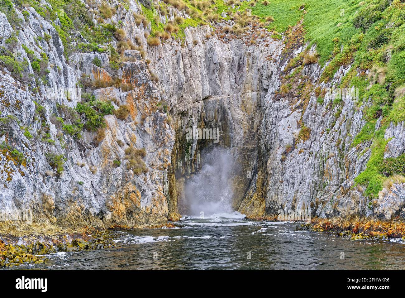 Blowhole spraying water up cliff face on Breaksea Islands, Bathurst ...