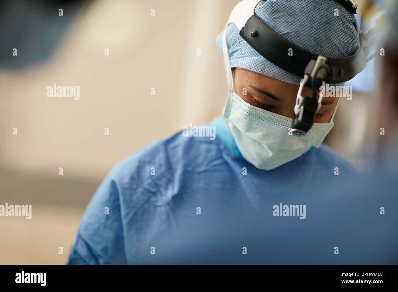 Focused on a very precise procedure. a surgeon performing a surgery in ...