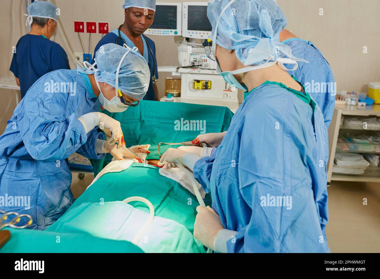 Dedicated to saving lives. a team of surgeons performing a surgery in ...