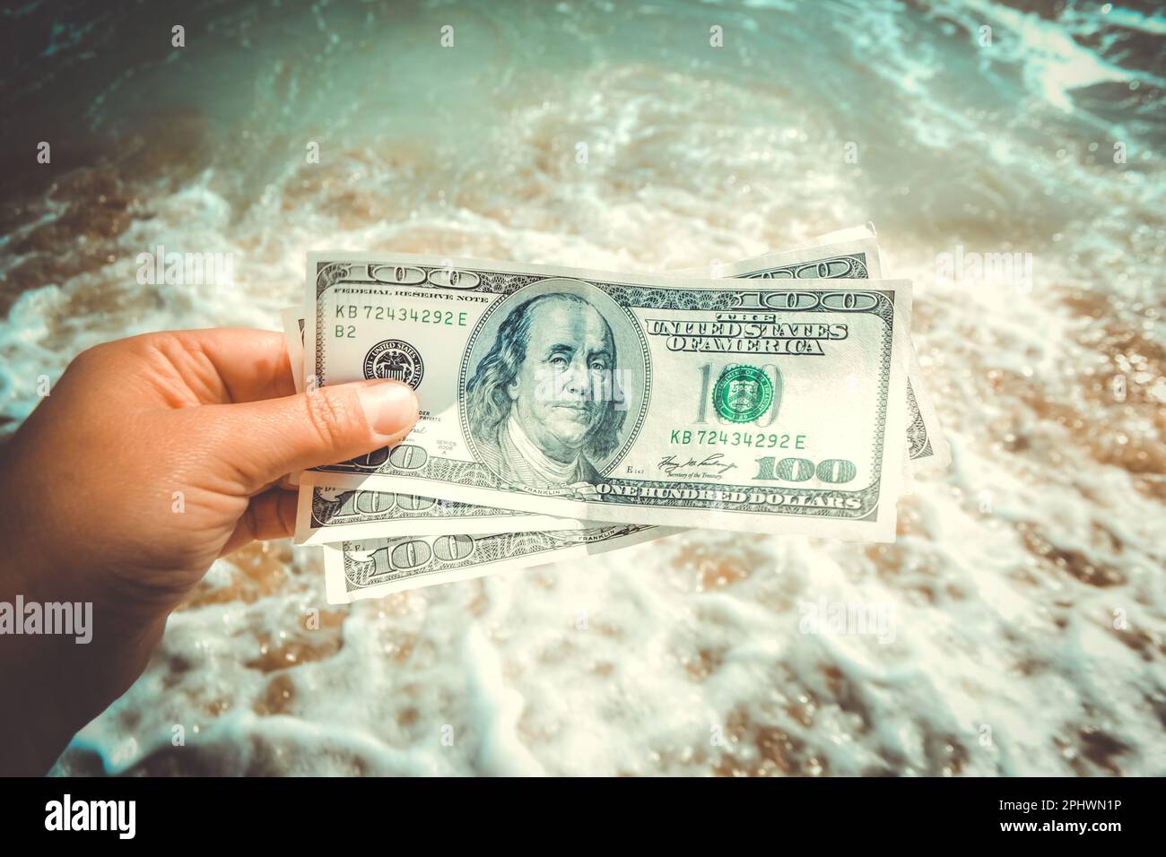 Girl holding money bill of 300 dollars on background of sea oceans ...