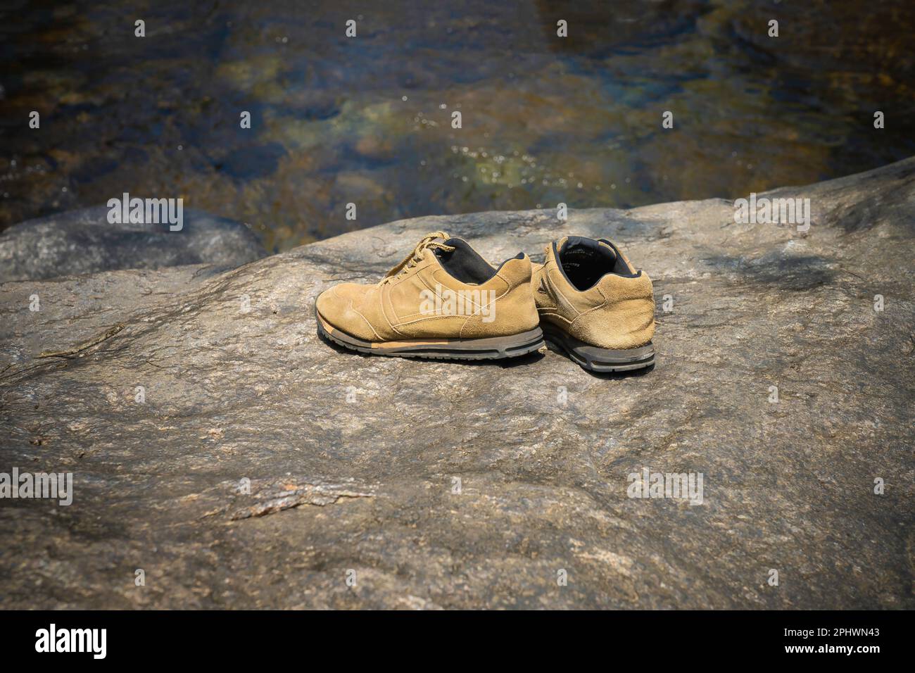 shoes on rock dark background Stock Photo - Alamy